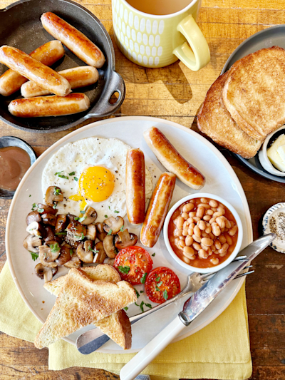 Full English Breakfast with Pork Sausages, Sunny Side Up Eggs and Baked ...