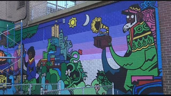 Kids paint mural on NYCHA building to promote peace
