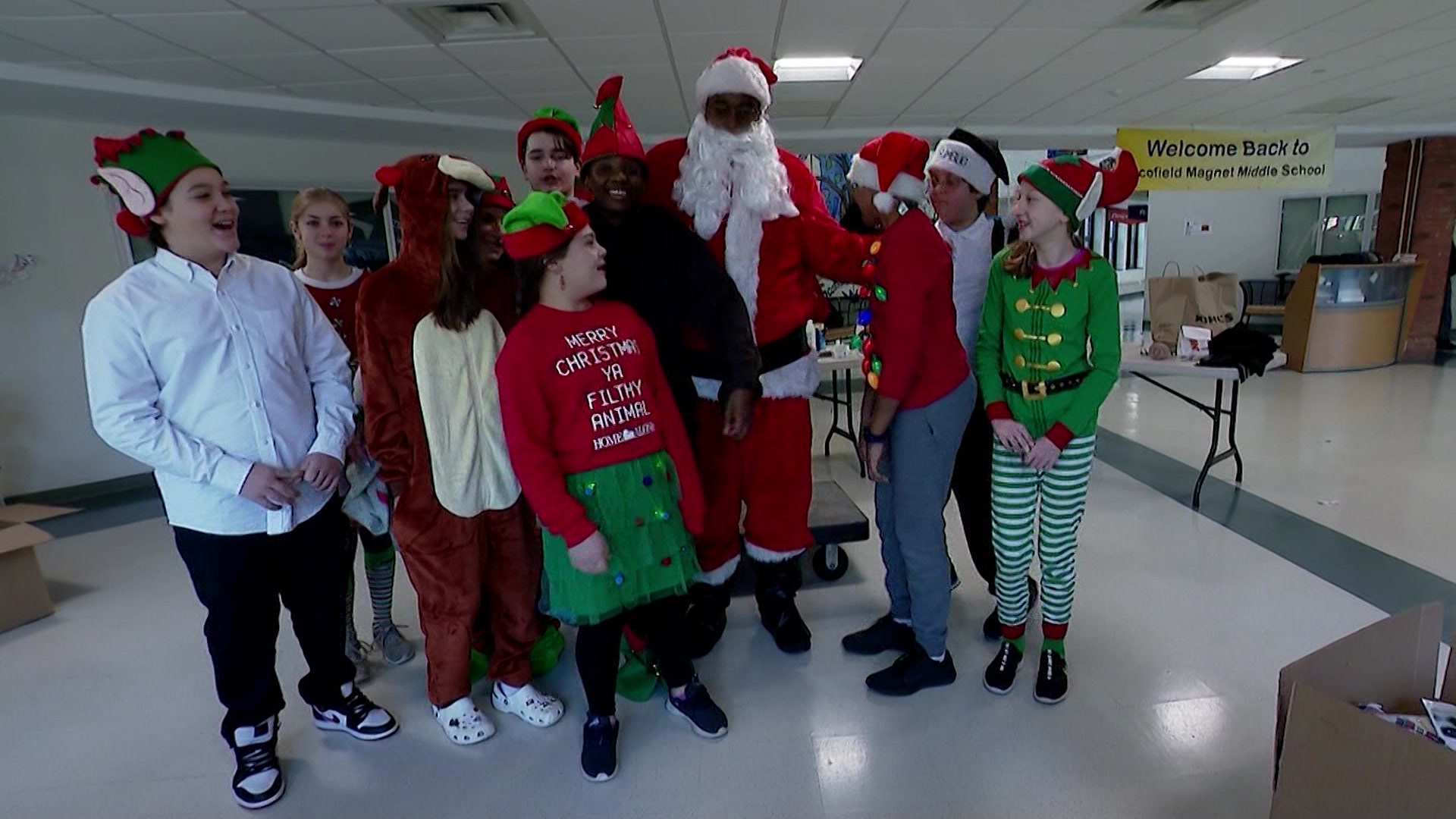 Scofield Magnet Middle School student elves fill boxes for homeless shelter