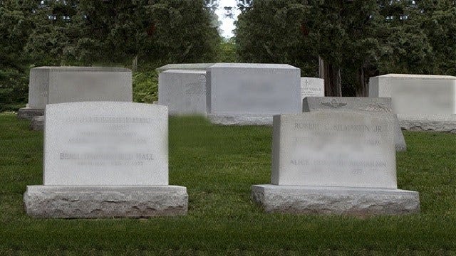 Cemetery worker trapped in open grave by accidental fall