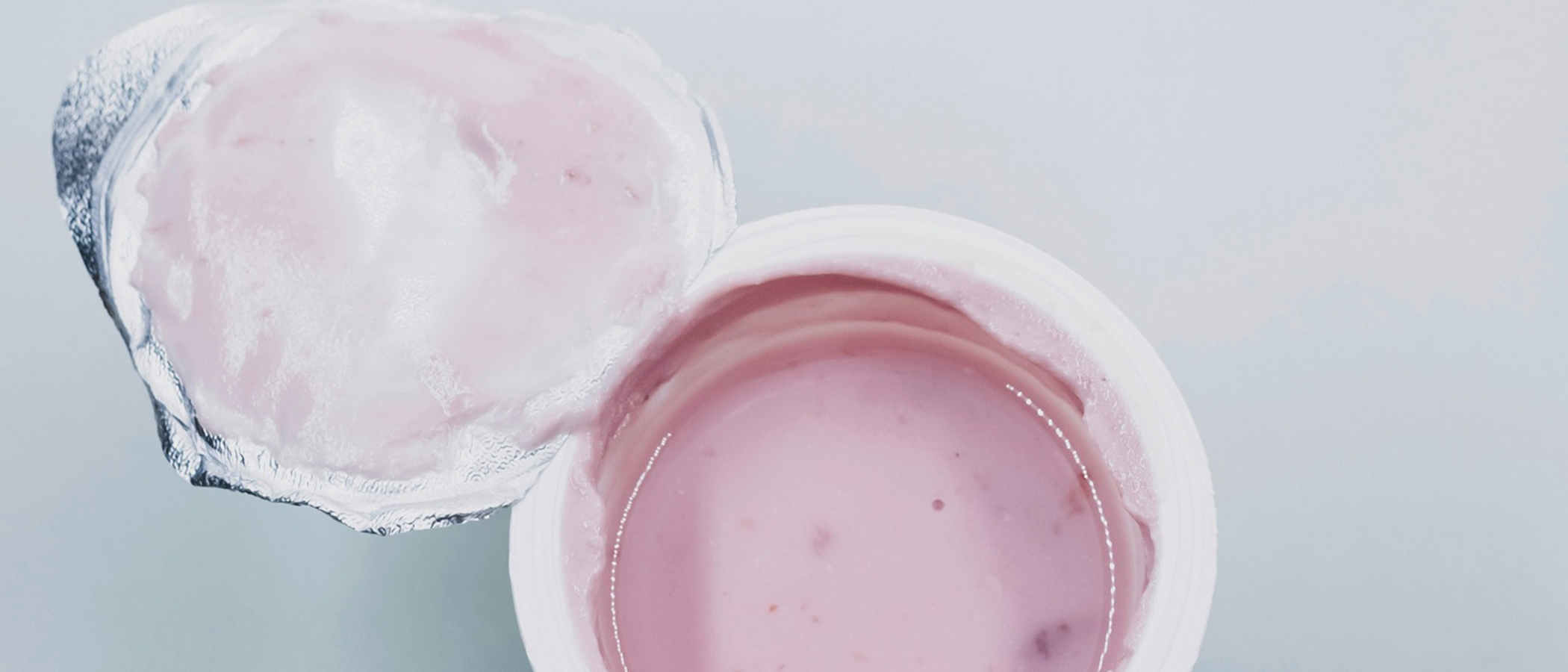 Licking a yoghurt lid • Migros