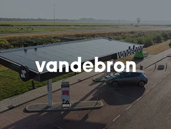 Vandebron logo overlaying a sustainable solar vehicle charging station