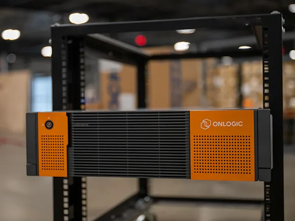 An OnLogic edge server mounted on a rack in a warehouse setting