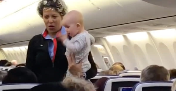 Flight Attendant Holds Baby to Give Mom a Break
