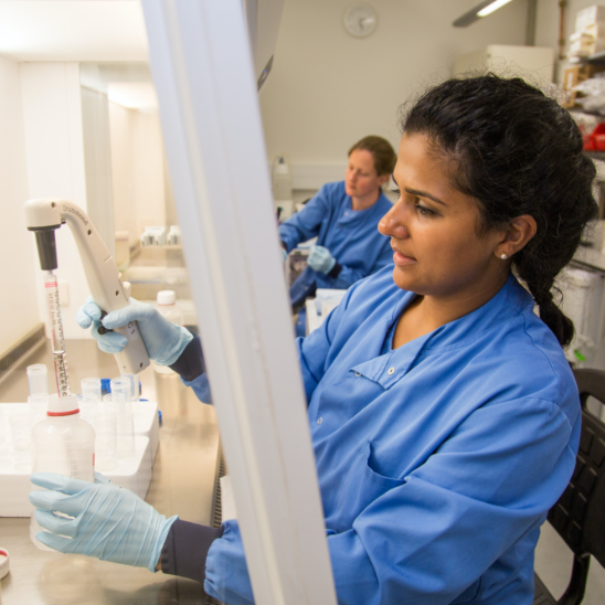 Girl holding a bottle in a lab