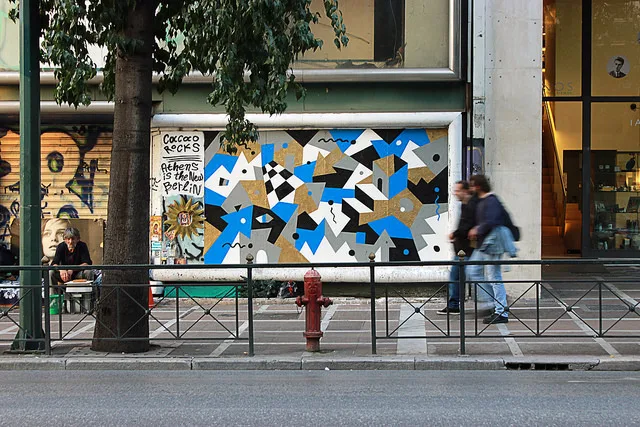 WePresent | Graffitist Cacao Rocks paints Athens blue and gold