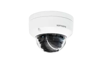 White dome security camera with dark lens housing mounted on ceiling.