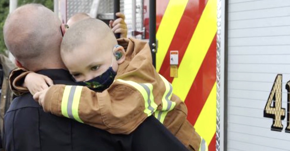 Sick Little Boy In A Medical Mask Clings To Firefighter. What’s Going ...