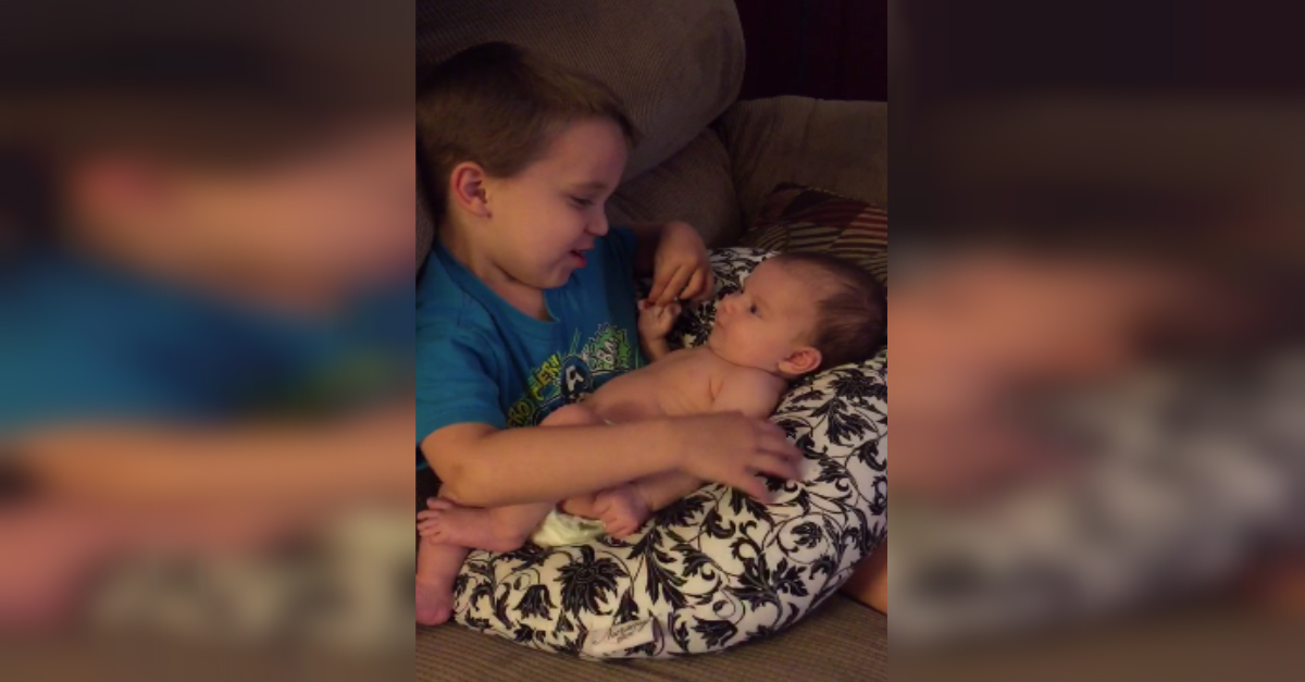Big Brother Cradles His Little Sister. But Watch As He Opens His Mouth ...