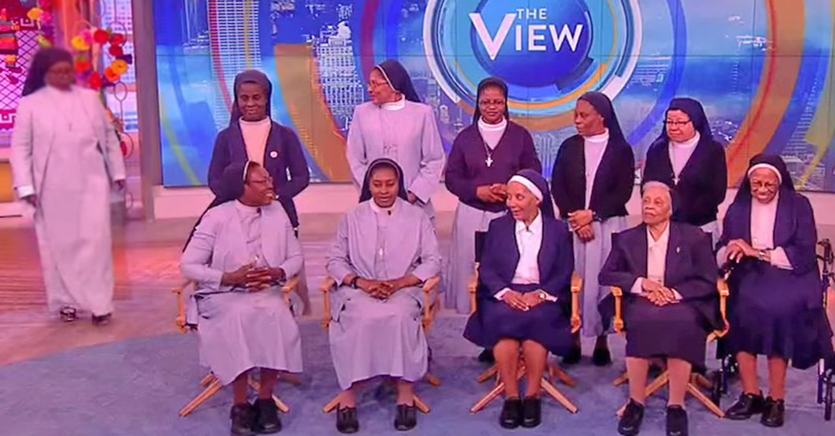 10 Nuns In Purple Sit Onstage. When Another Nun Sneaks Up From Behind ...