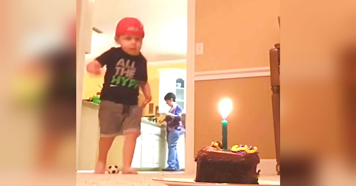 Little Boy Spots Candle In Cake, Blows It Out With Kick | LittleThings.com
