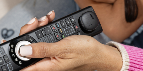 A Tile Sticker Black attached to a television remote.