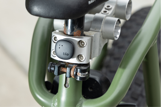 A Tile Sticker Black placed on the back seat of a bicycle.