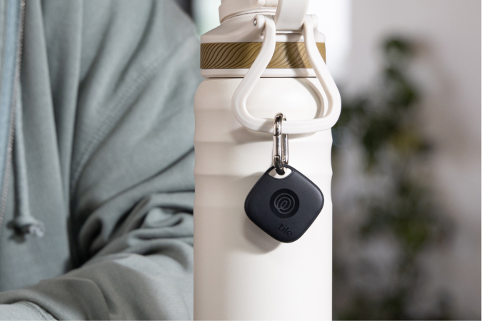 A Tile Mate Black attached to a water bottle.