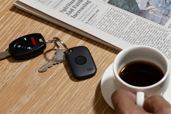 A person having a coffee, has their keys placed on the table. Attach a ...