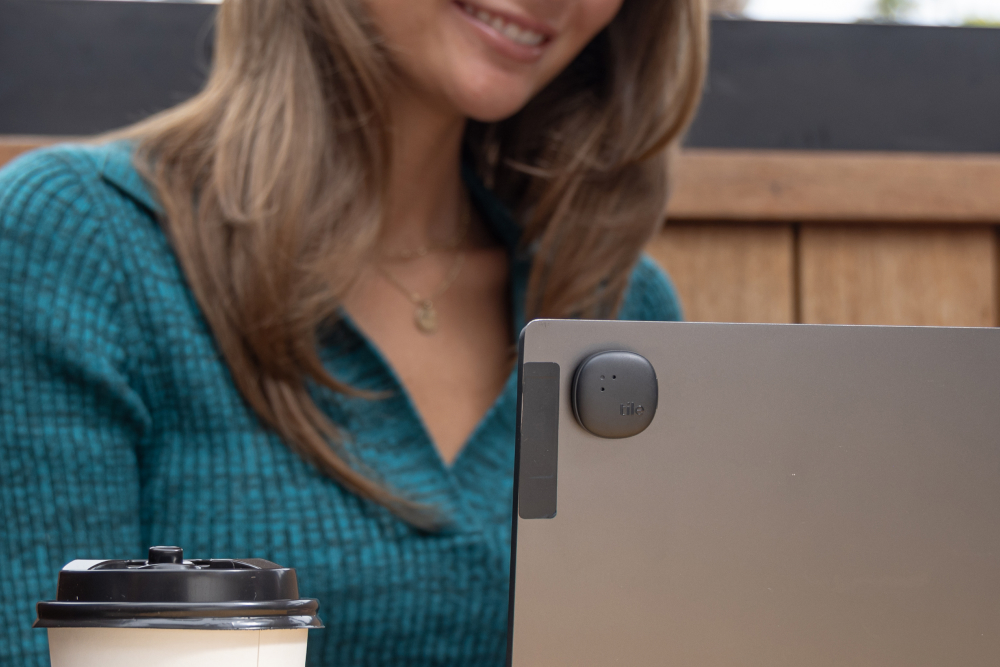 A Tile Sticker Black placed on a laptop.
