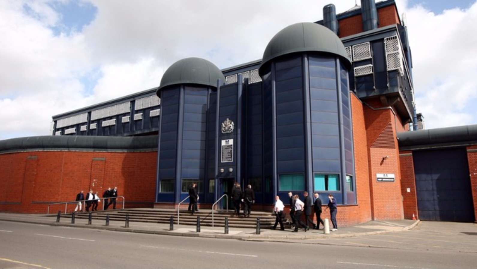 Inmate scales prison roof and hurls tiles at wardens in dramatic ...