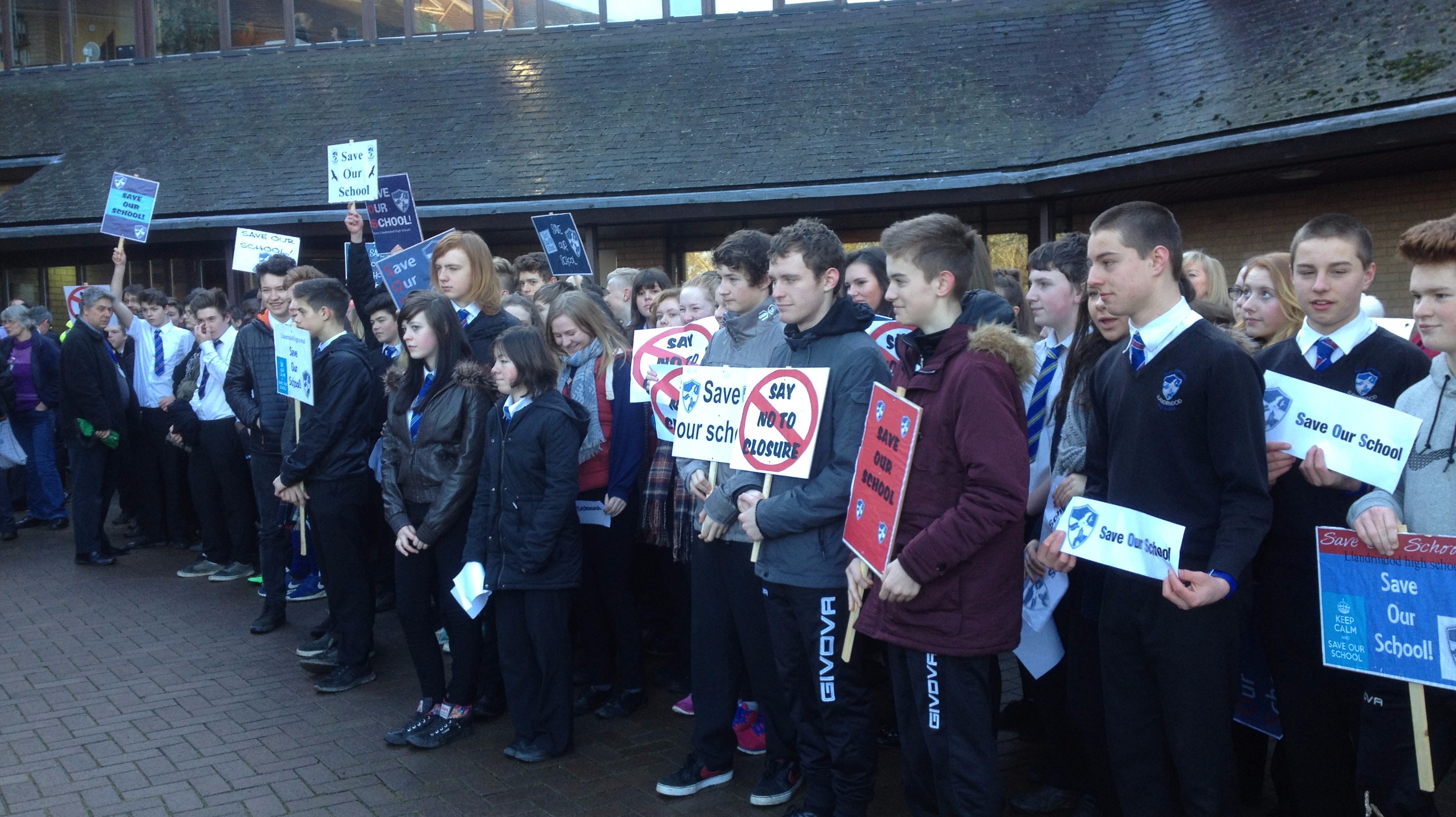 Hundreds protest over plans to merge Powys secondary schools | ITV News ...