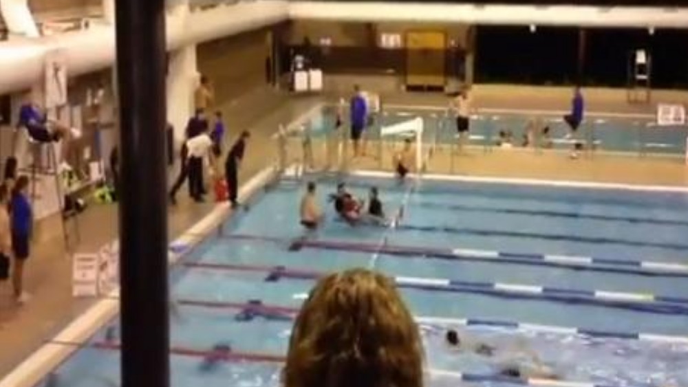 Police jump into pool fully clothed to restrain swimmer | ITV News