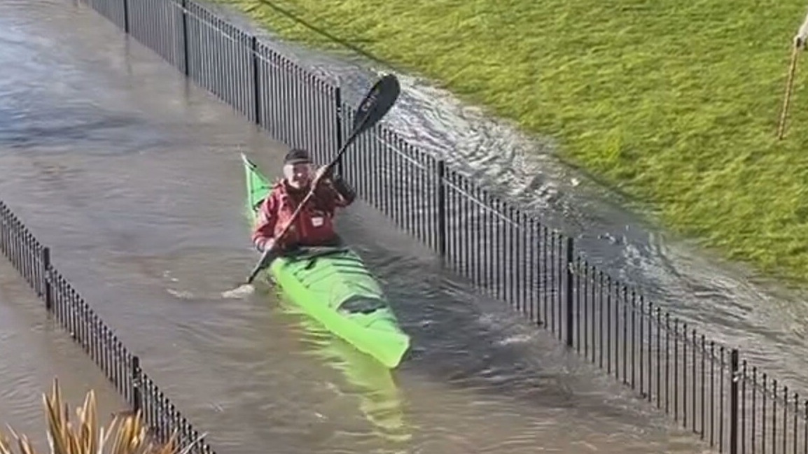 Kayaker inspects damage done by Storm Henk by rowing through floodwater ...