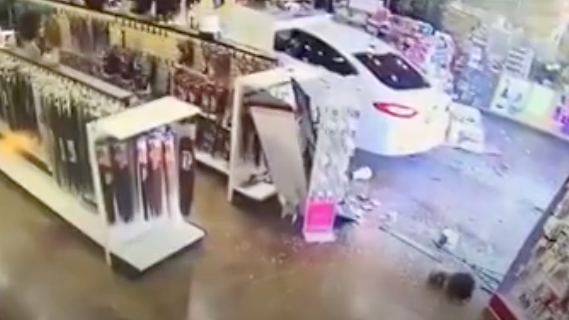 Shop workers escape with only minor injuries after car crashes through ...