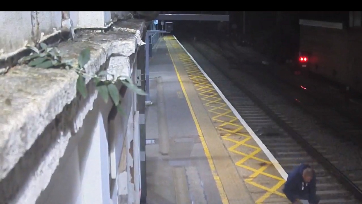 Watch moment train speeds over drunk man who lay on train tracks in ...