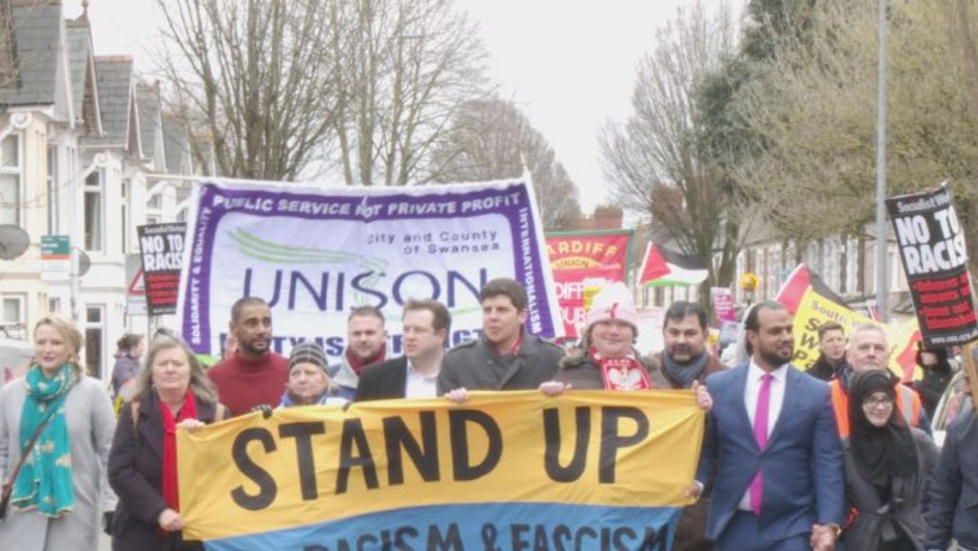 Hundreds turn out for anti-racism march after neo-Nazi graffiti ...
