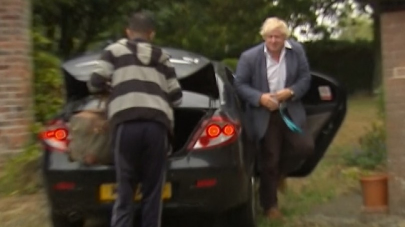 Boris Johnson greets the media armed with a tray of mugs as he makes ...