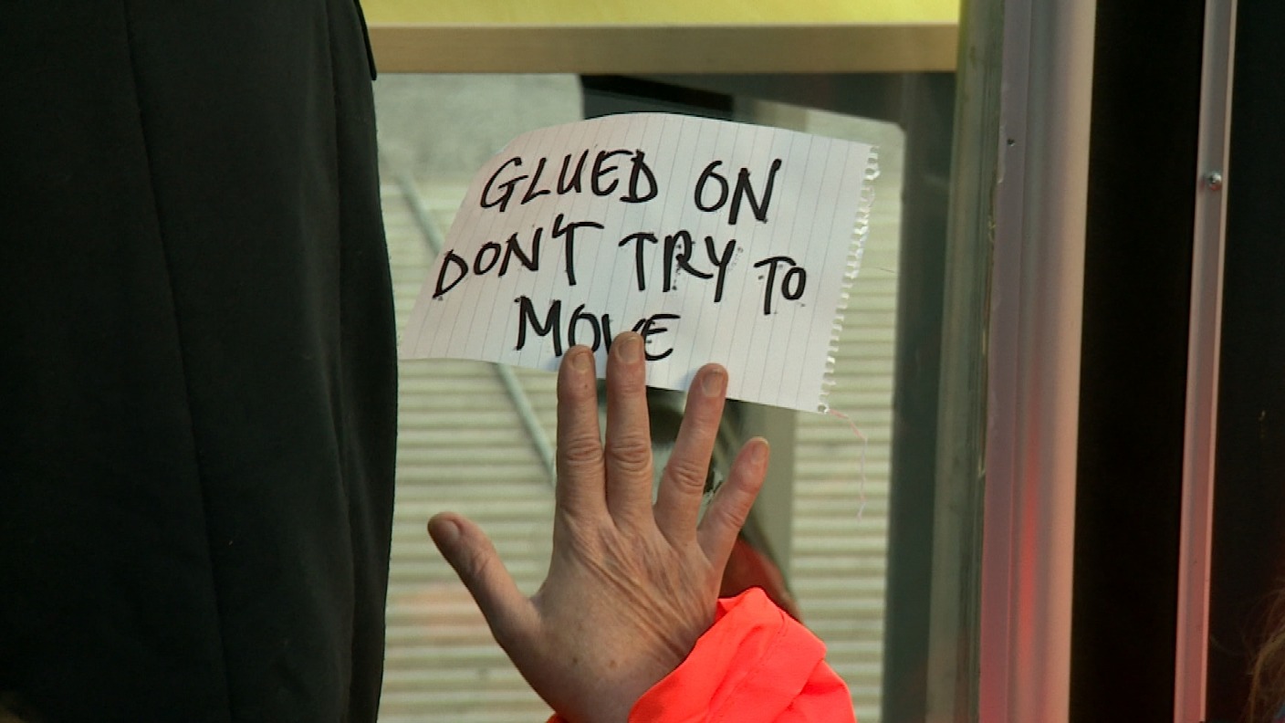 Fracking protesters glue themselves to Government building | ITV News
