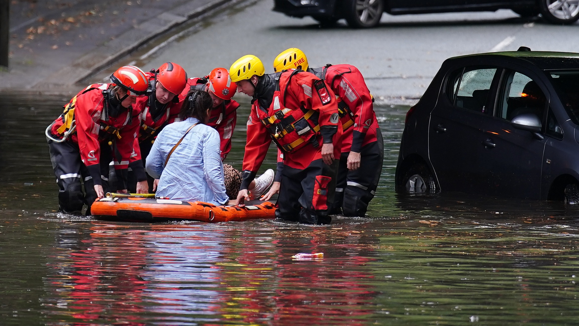 Driver rescued from car in Liverpool as heavy rain causes flooding ...