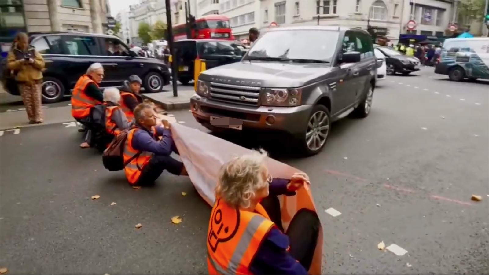 Just Stop Oil protesters stop traffic at Holborn junction after gluing ... Just Stop Oil protesters stop traffic at Holborn junction after gluing ...