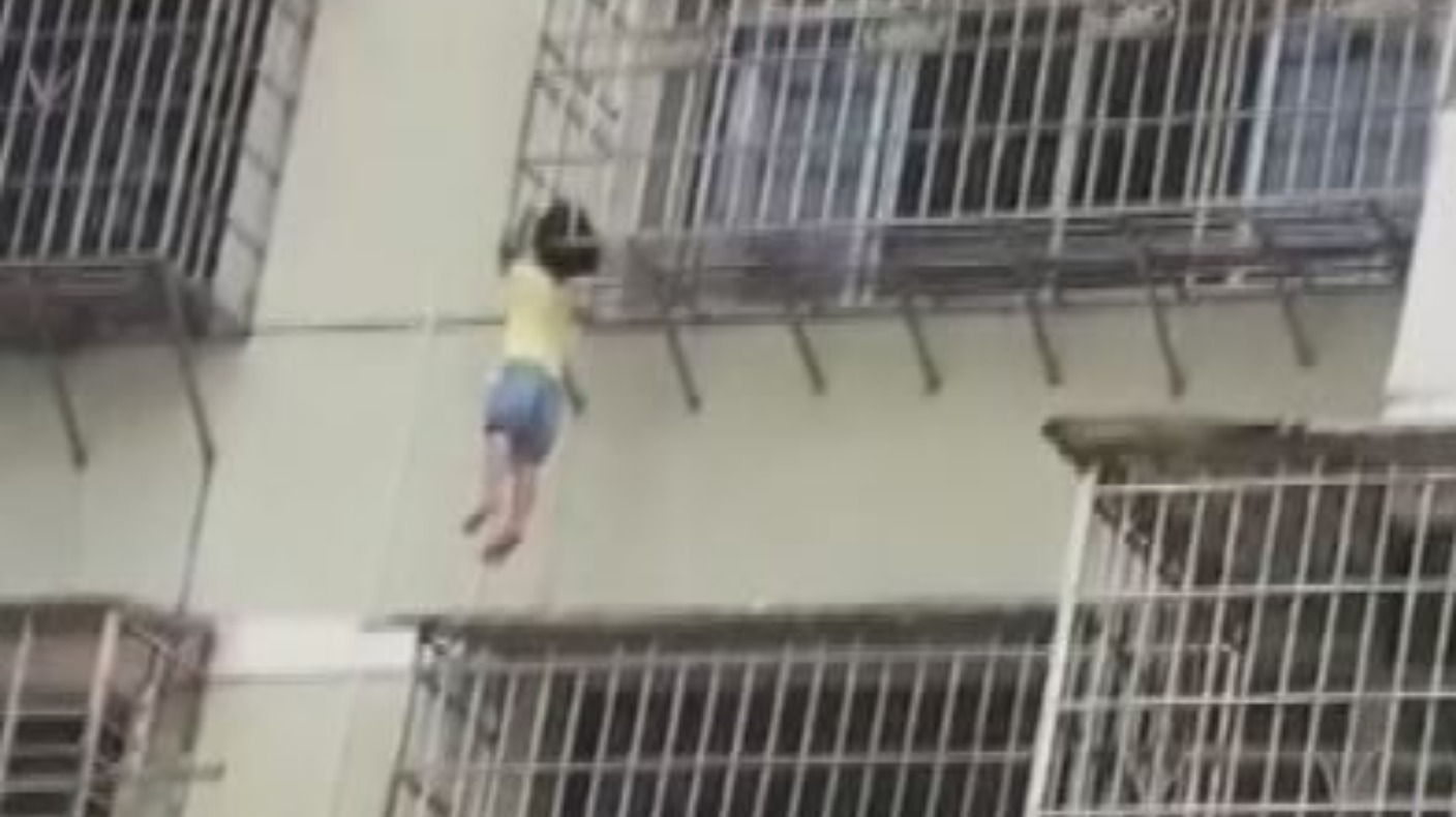 Girl, five, narrowly avoids seven storey fall after head gets stuck in ...