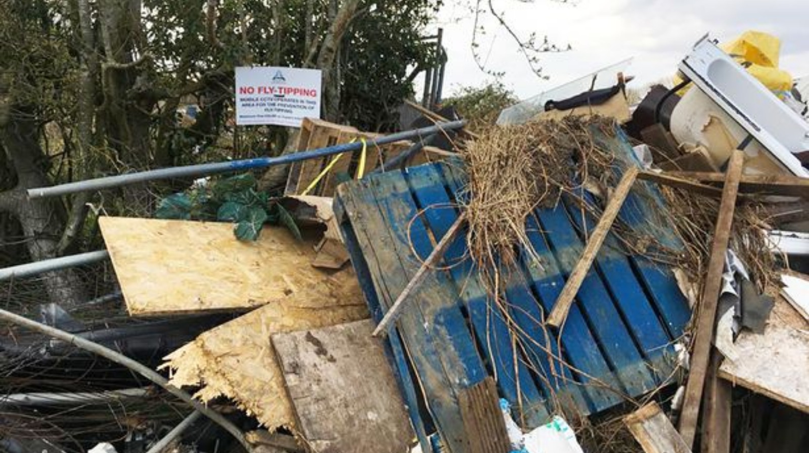 Huge flytip dumped next to sign which highlights consequences of ...