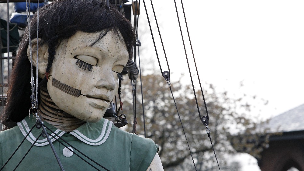 Giant puppets stride across Liverpool to commemorate Titanic sinking ...