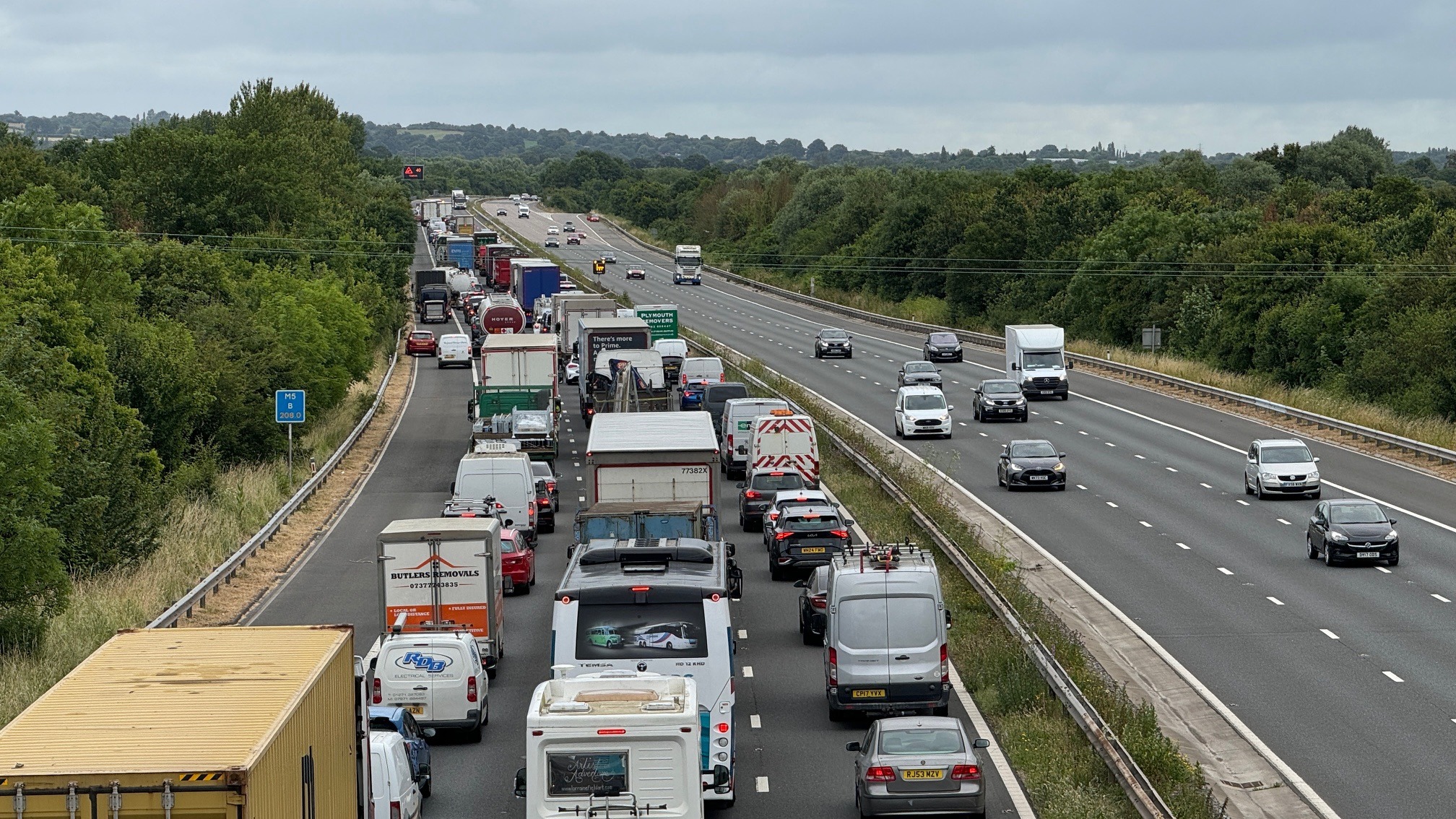 M5 traffic: Delays after lorry crashes into bridge prompting warning ...