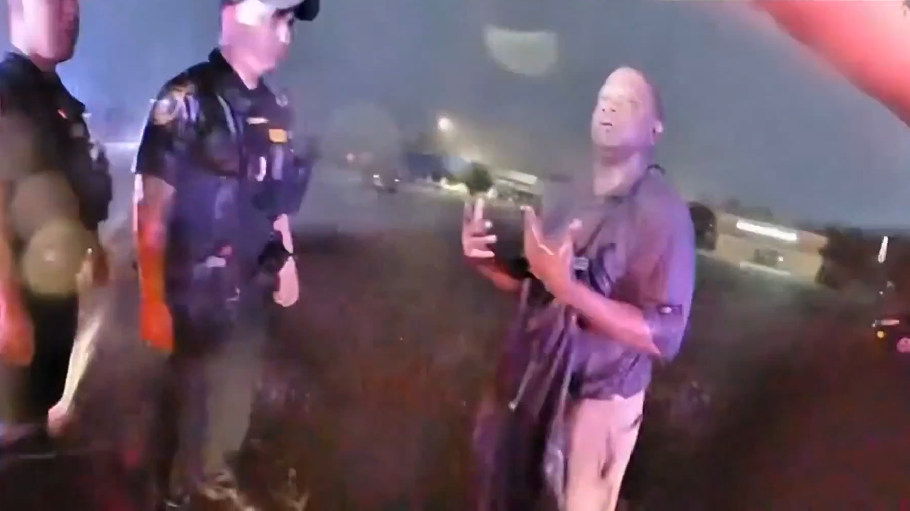 Bodycam captures police officer and motorist being sucked into drain ...