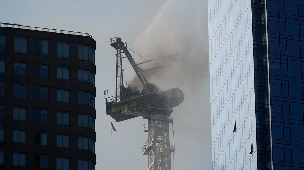 Crane catches fire and collapses onto busy New York street | ITV News