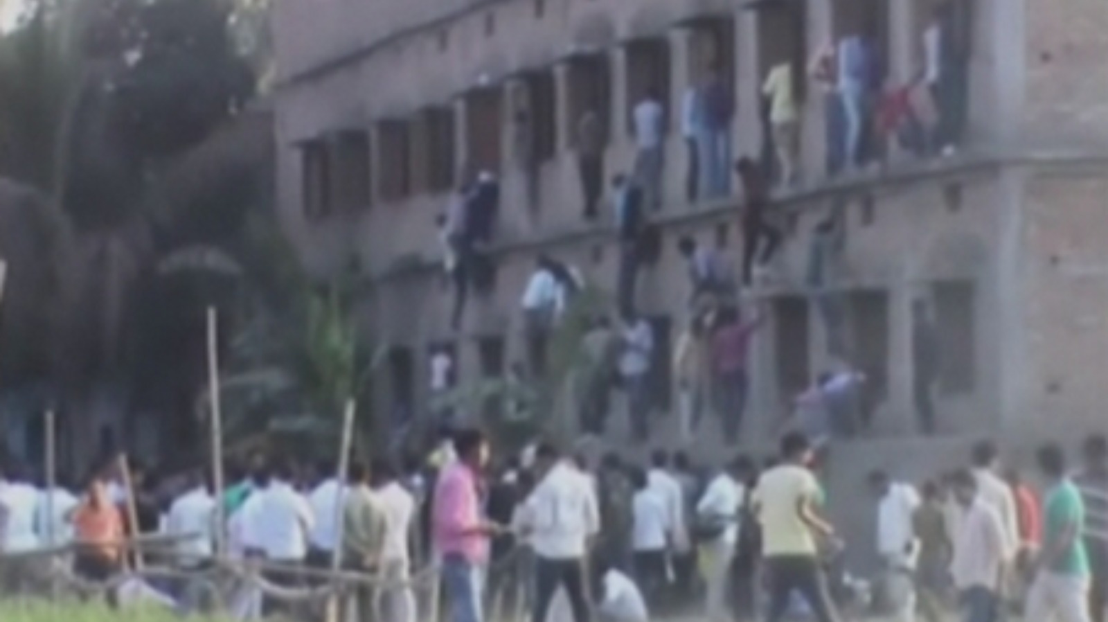 Footage of parents scaling school walls to throw cheat notes inside ...
