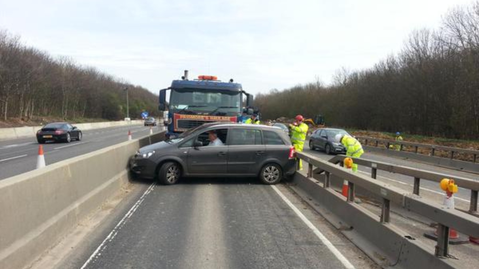 Car gets wedged at exact 90 degree angle between barriers after hitting ...