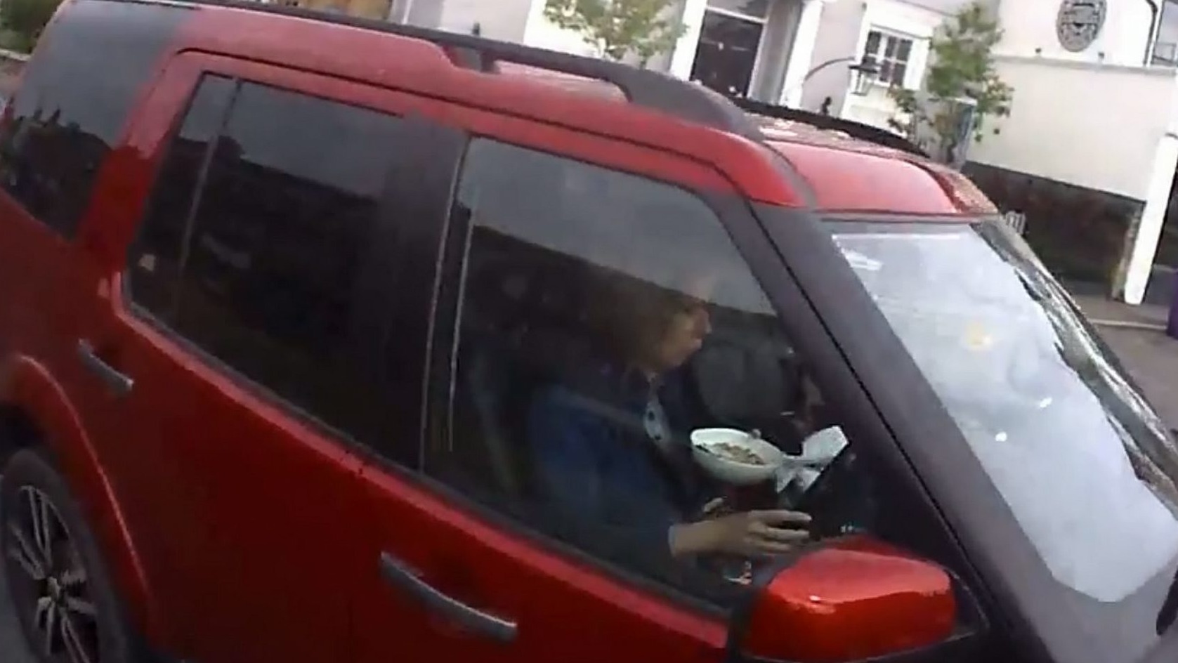 Woman filmed eating a bowl of Shreddies at the wheel of her Land Rover ...