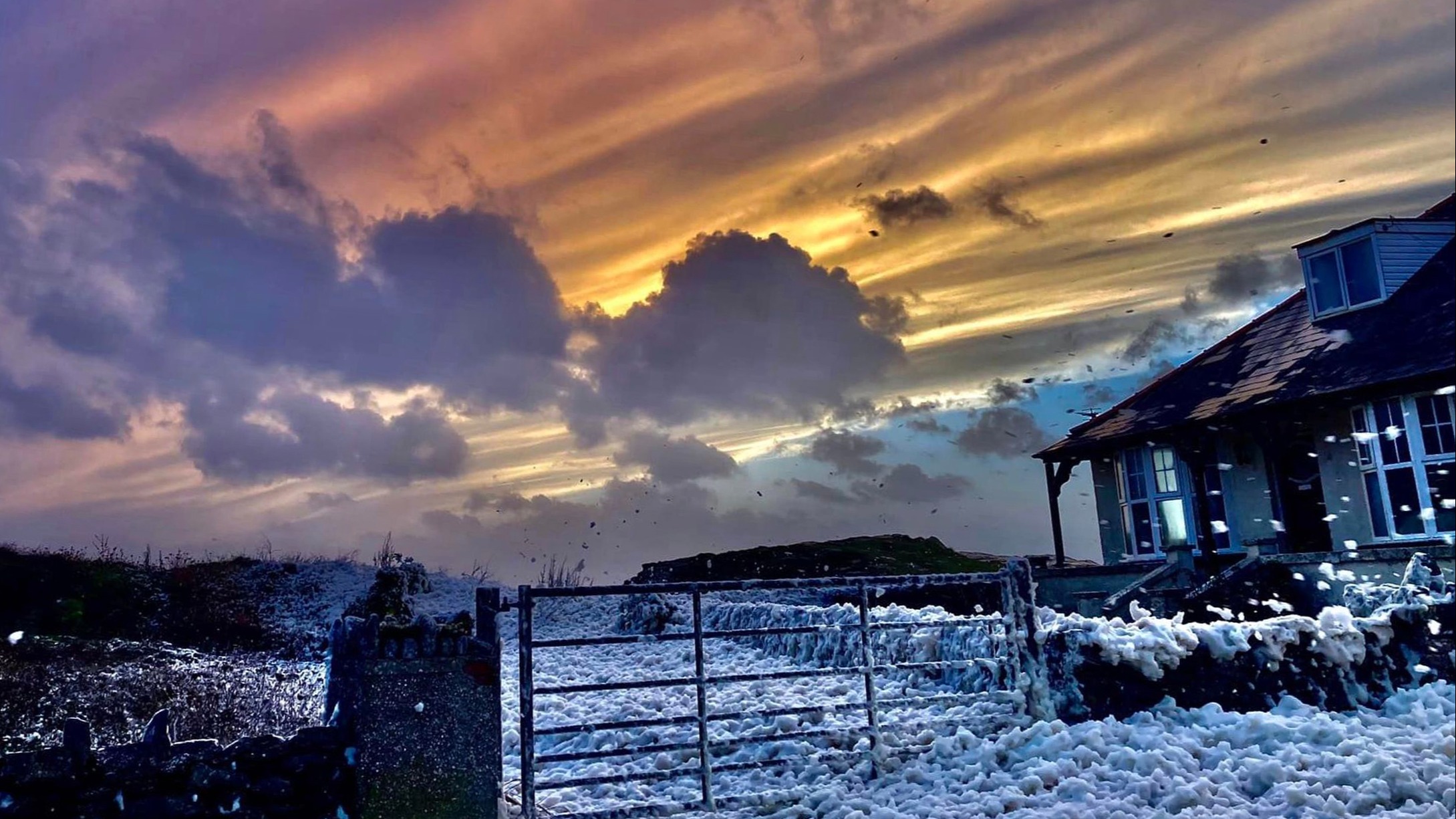 Anglesey bay blanketed in sea foam after Storm Claudio in strange ...