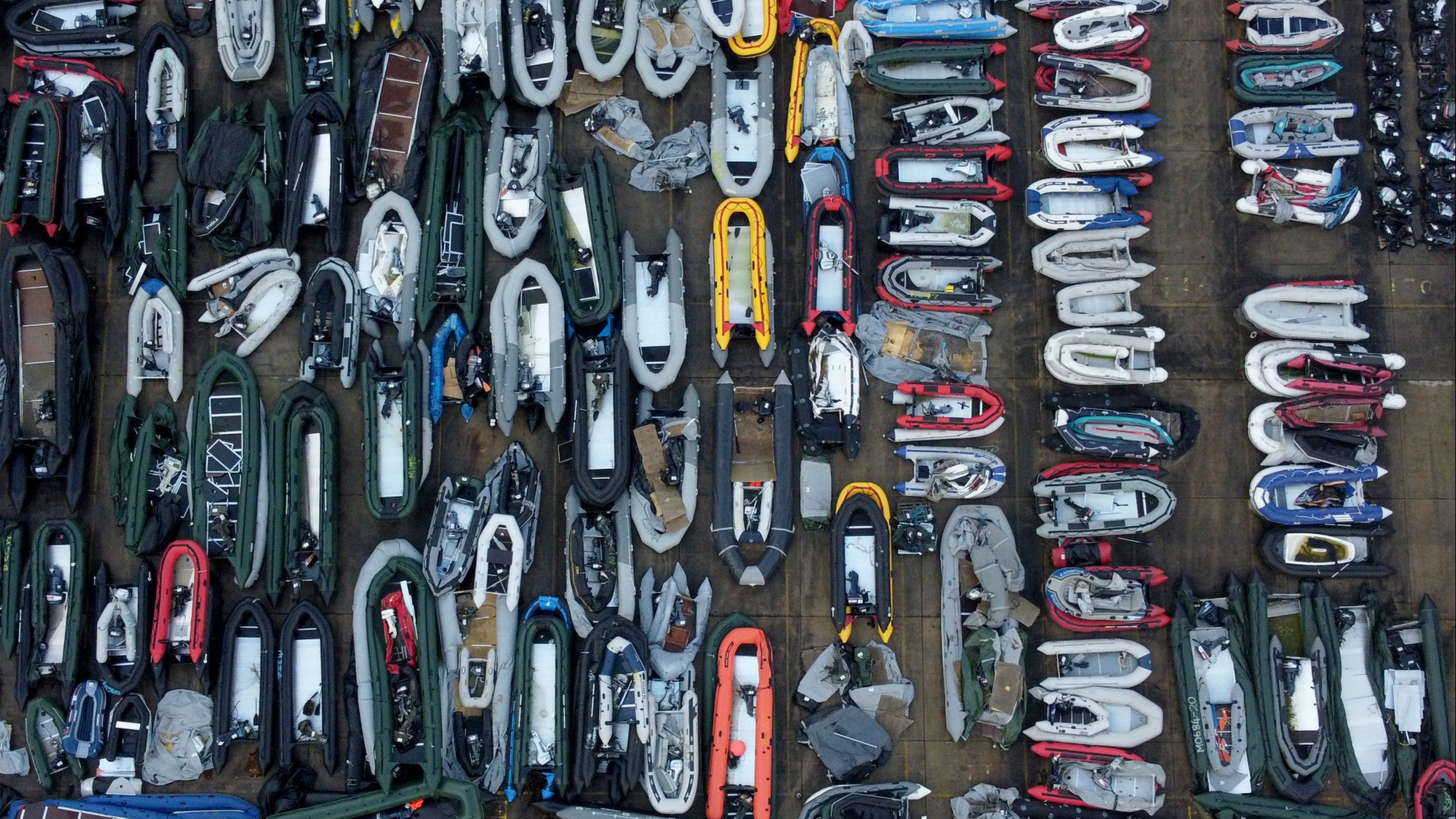 Drone pictures show dozens of migrant dinghies stacked up in Dover ...
