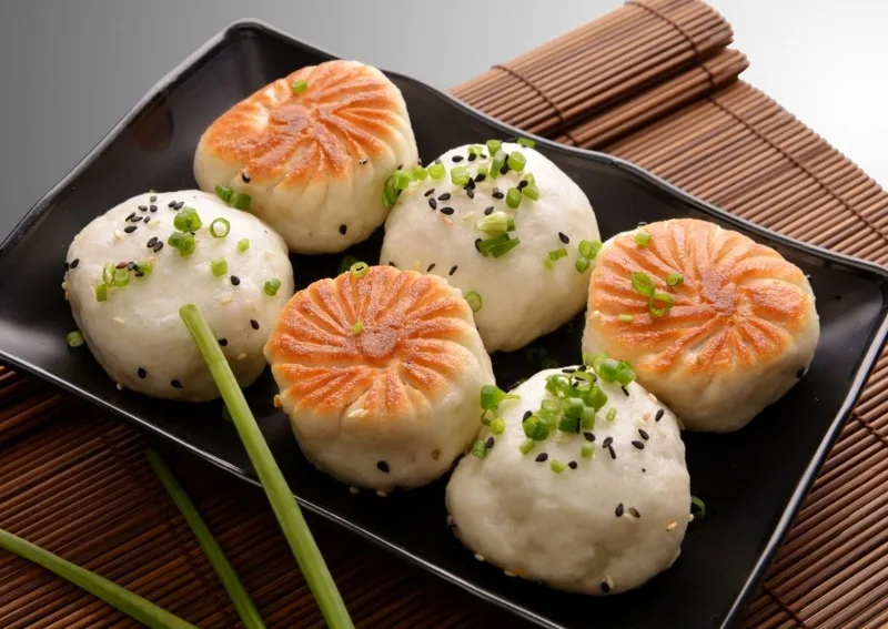 Xiaolongbao (小笼包): Steamed soup dumplings filled with pork and a savory ...