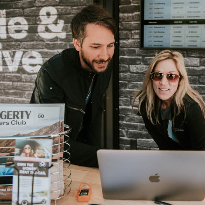 Hagerty car experts researching on a laptop