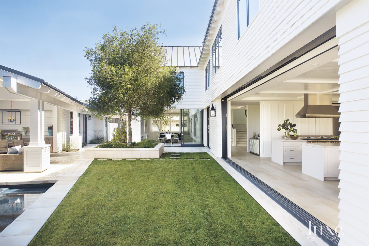 Traditional White L-Shaped Courtyard | Luxe Interiors + Design