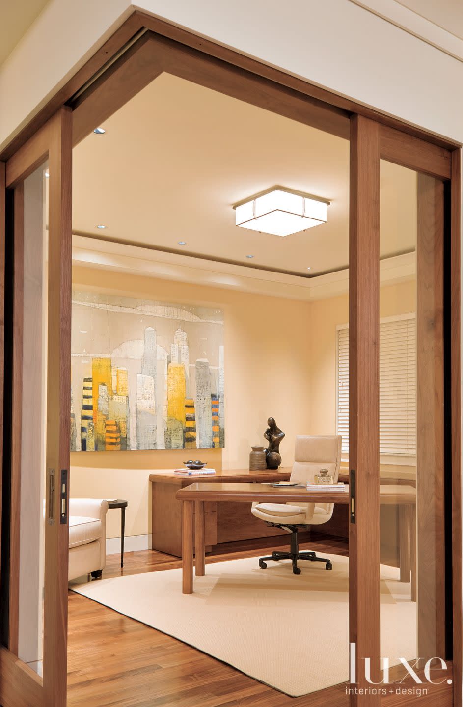 Contemporary Cream Office with Skyline Artwork | LUXE Interiors + Design
